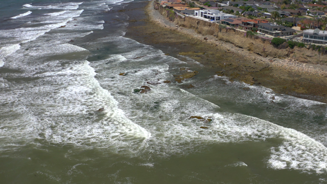 Flying northbound along the cliffs and beachside homes of Bird Rock ...